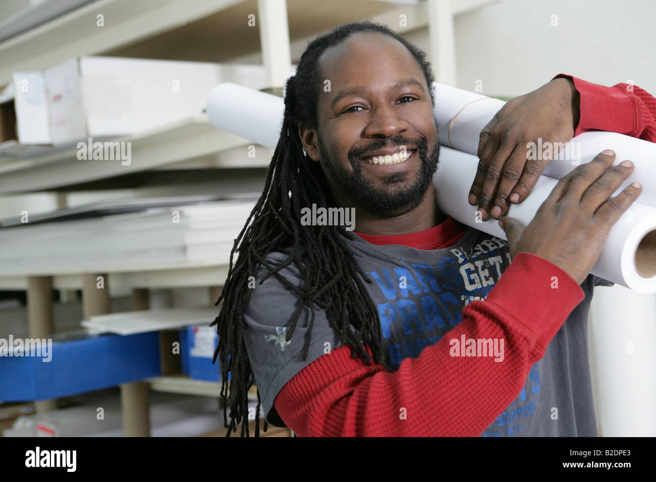 African American man holding rolls of paper Stock Photo - Alamy