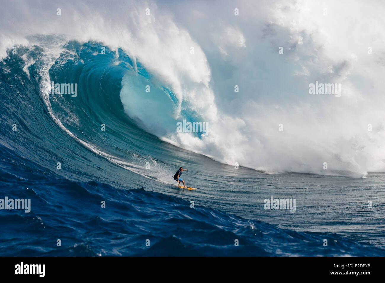 A tow-in surfer drops to the curl of Hawaii's big surf at Peahi (Jaws ...