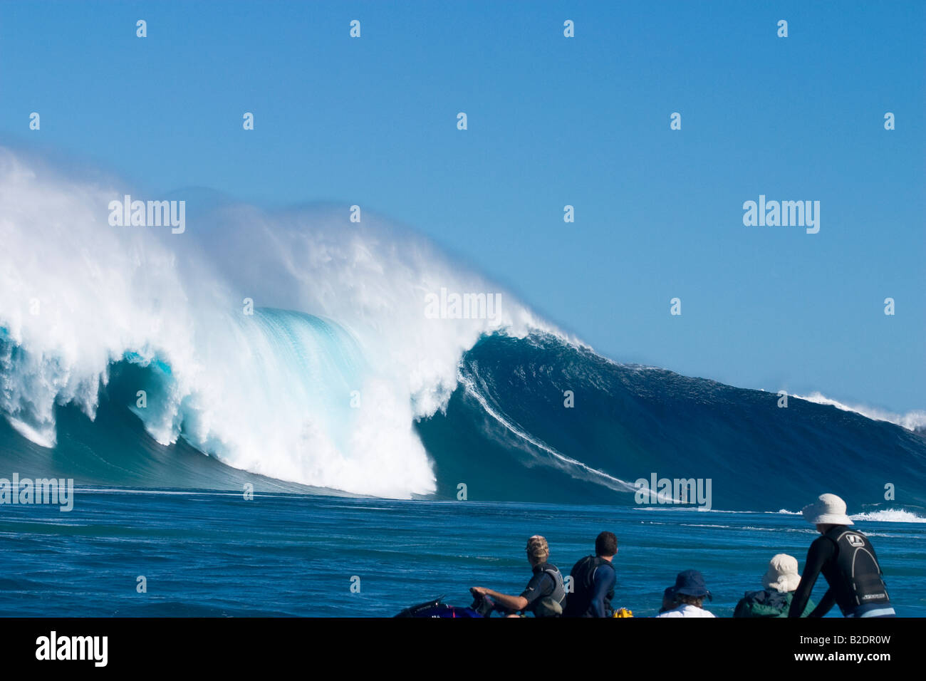 With an on water audience a tow-in surfer takes a left at Hawaii's big ...