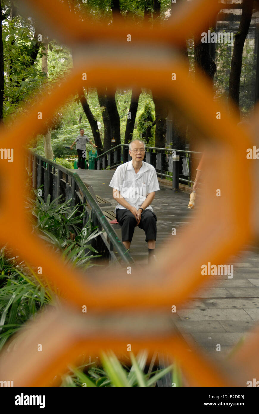 man relaxing in the tranquility of the tai chi Garden in Hong Kong Park ...