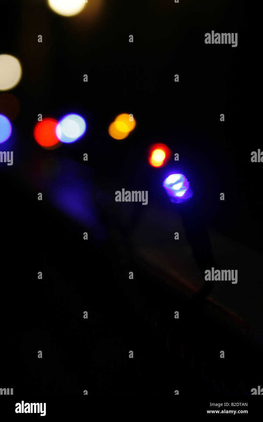 bright fairy lights in dark city street at night Stock Photo - Alamy