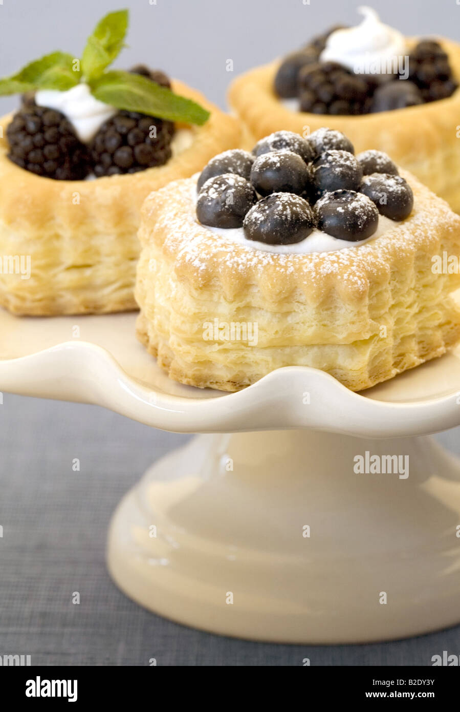 A group of Blueberry Pastries on a cake stand Stock Photo - Alamy
