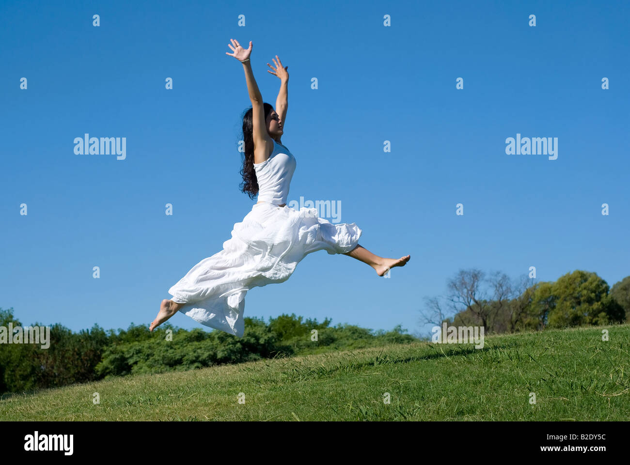 Jump in a white dress Stock Photo - Alamy