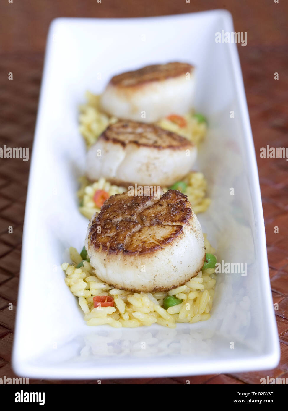 Pan seared Sea Scallops with rice Stock Photo - Alamy