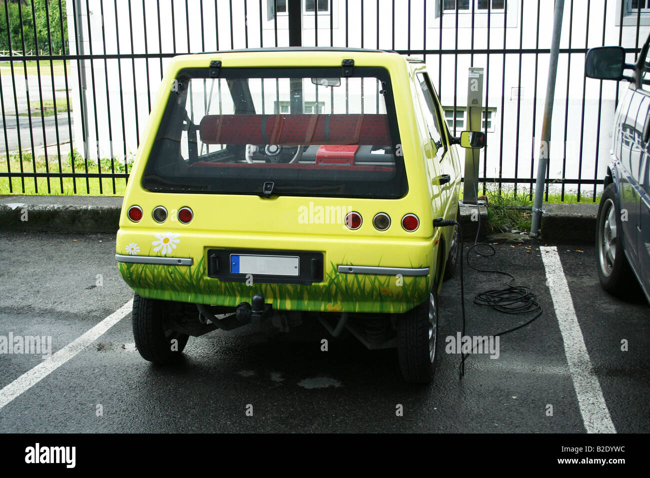 ecology car electromobile charging on the parking Stock Photo - Alamy