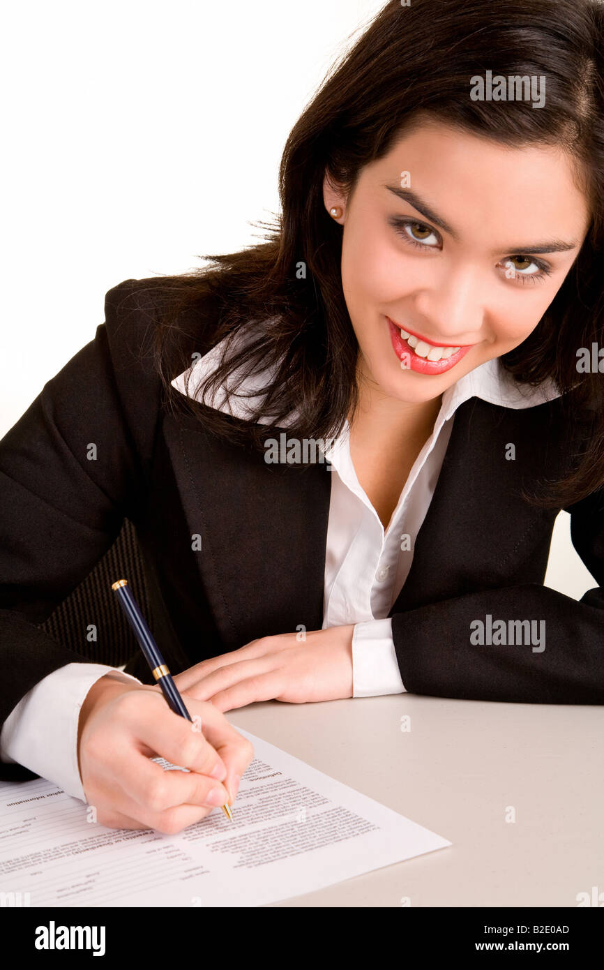 A beautiful young woman is signing a document Stock Photo - Alamy