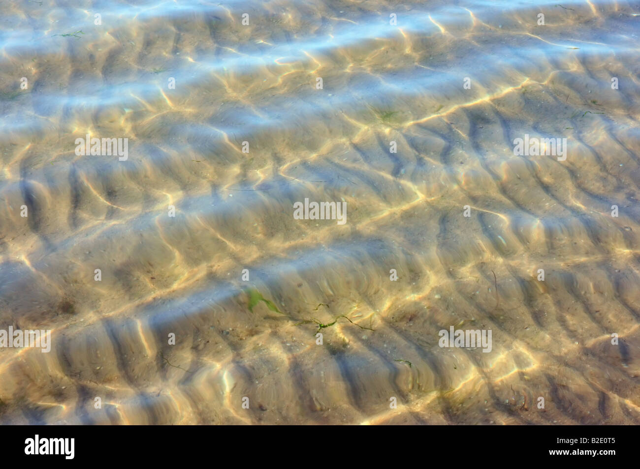 Sandy sea bottom in through water and waves on surface Stock Photo - Alamy