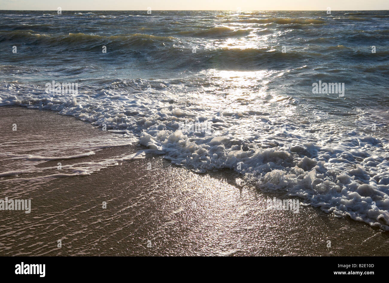 Coast surf and evening sunlight path on sea water surface Stock Photo ...