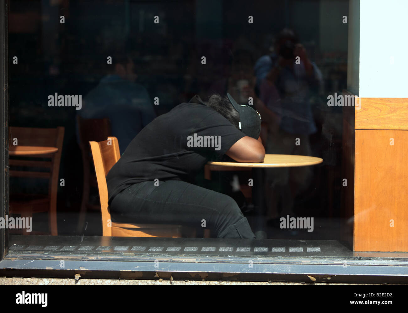 Exhausted & tired worker asleep in coffee shop Stock Photo - Alamy