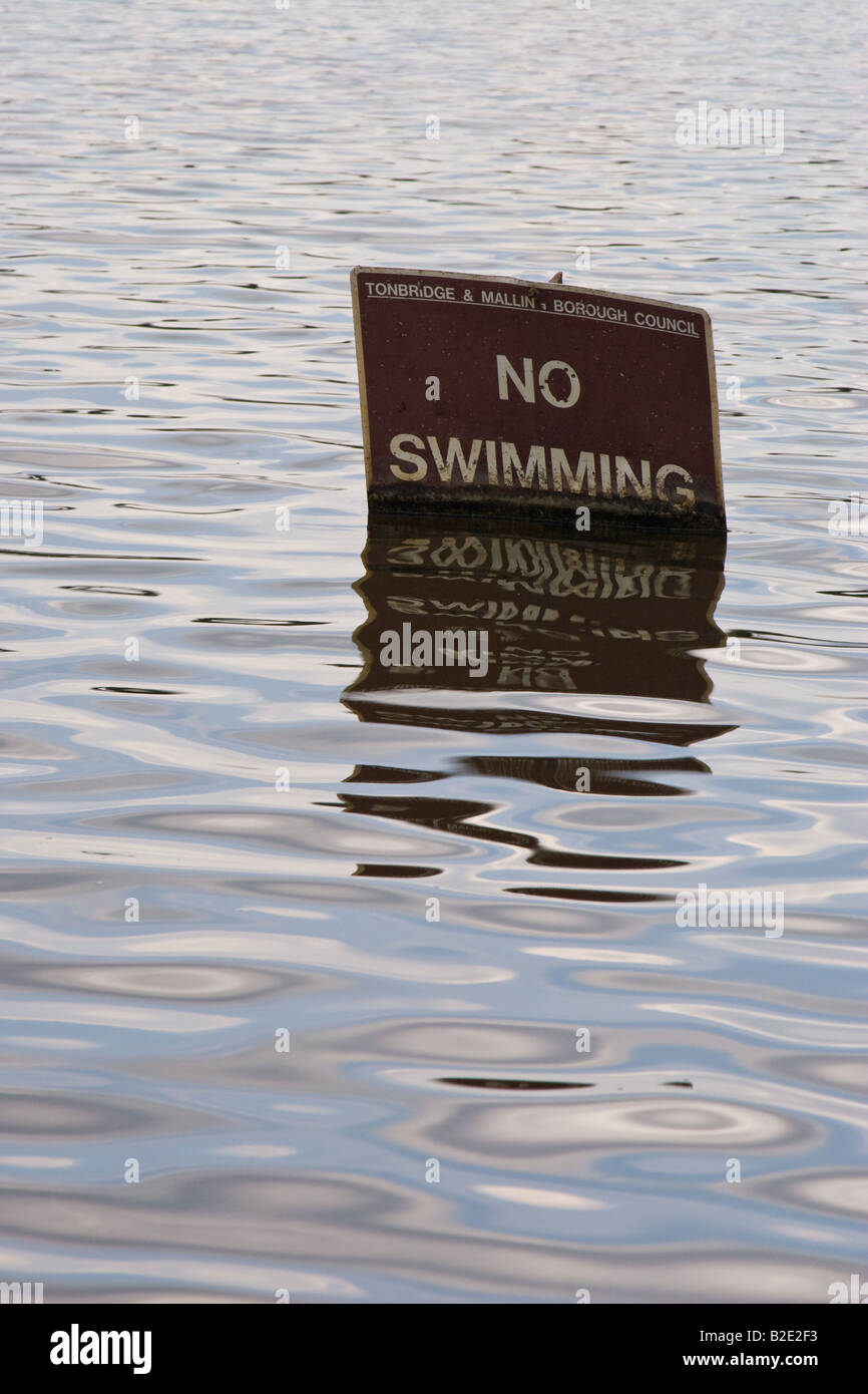 A No Swimming sign lies in a flooded lake Stock Photo - Alamy