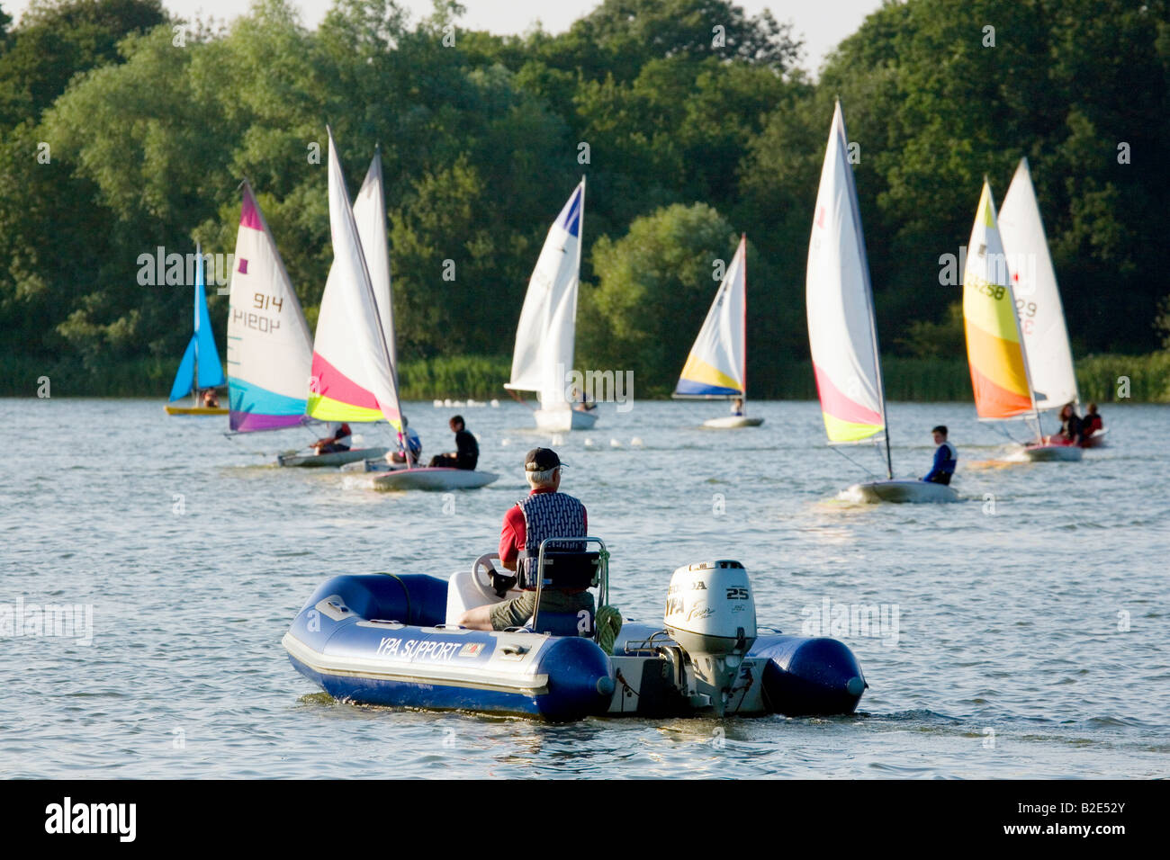 A sailing instructor and teenagers in their yachts during sailing ...