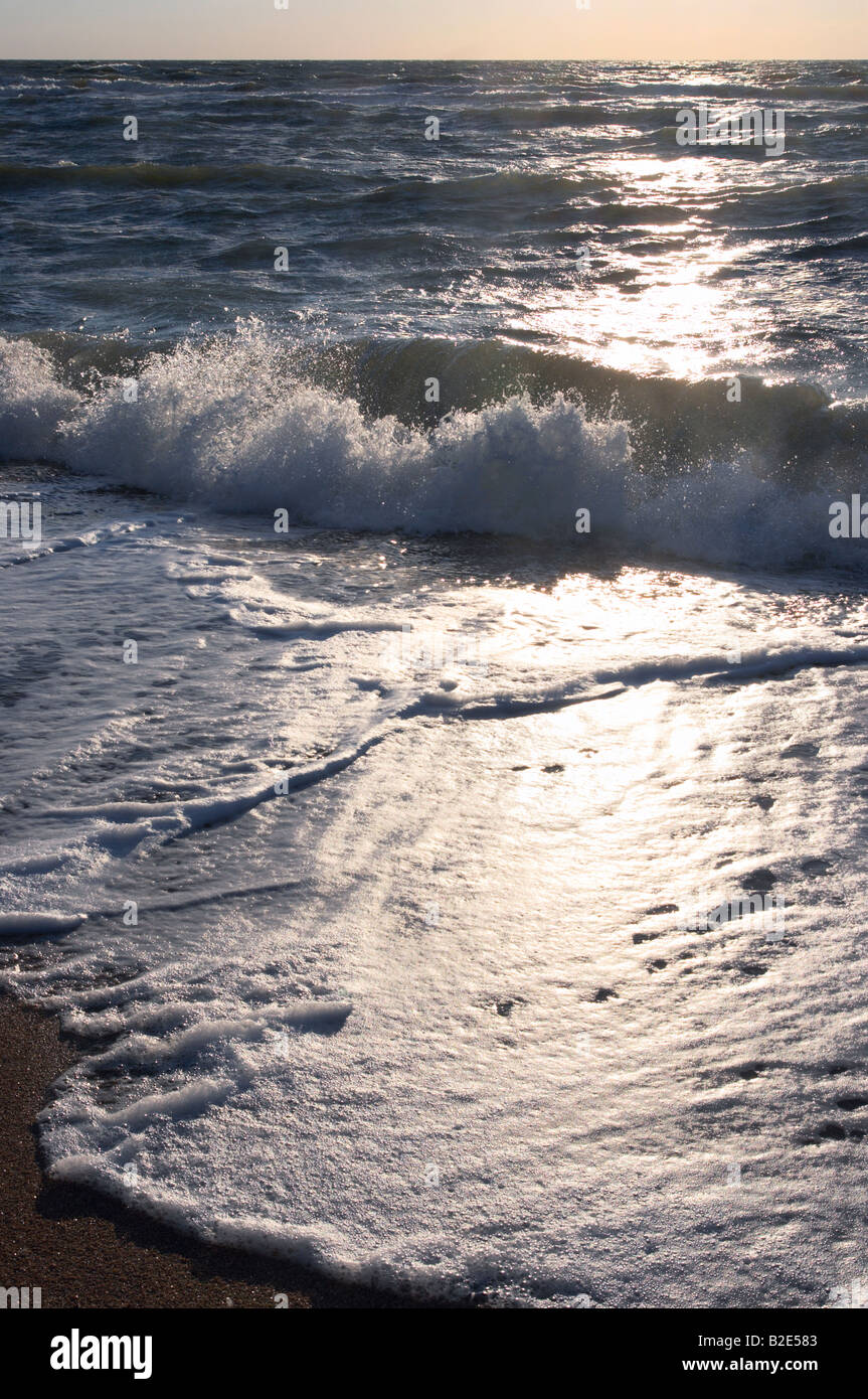 Coast surf and evening sunlight path on sea water surface Stock Photo ...