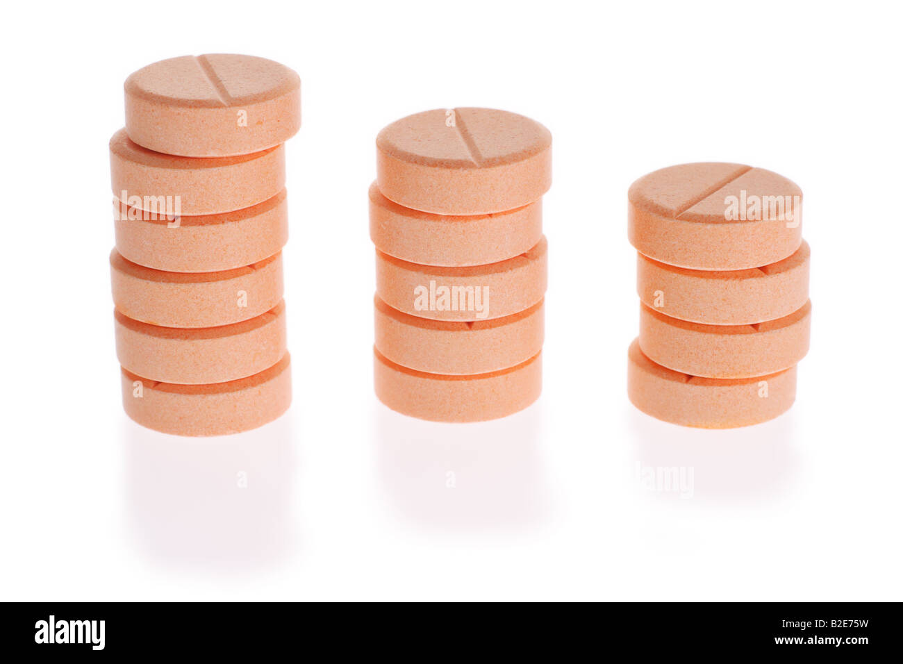 Three stacks of orange flavored tablets on white background Stock Photo ...