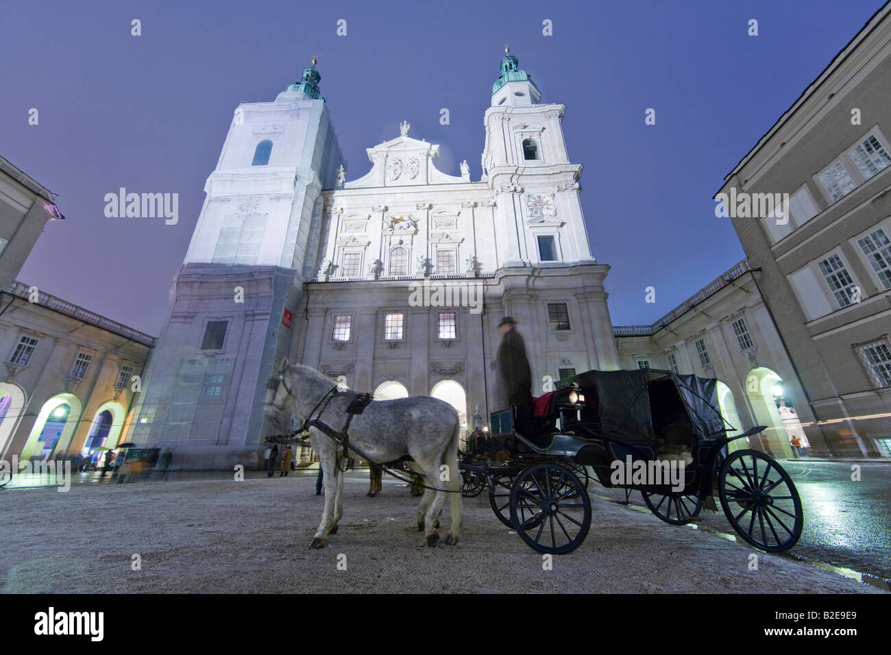 Side profile of coachman standing on horsedrawn carriage Stock Photo ...