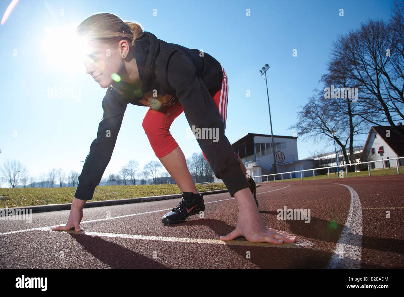 Close-up of teenage girl on starting blocks Stock Photo - Alamy