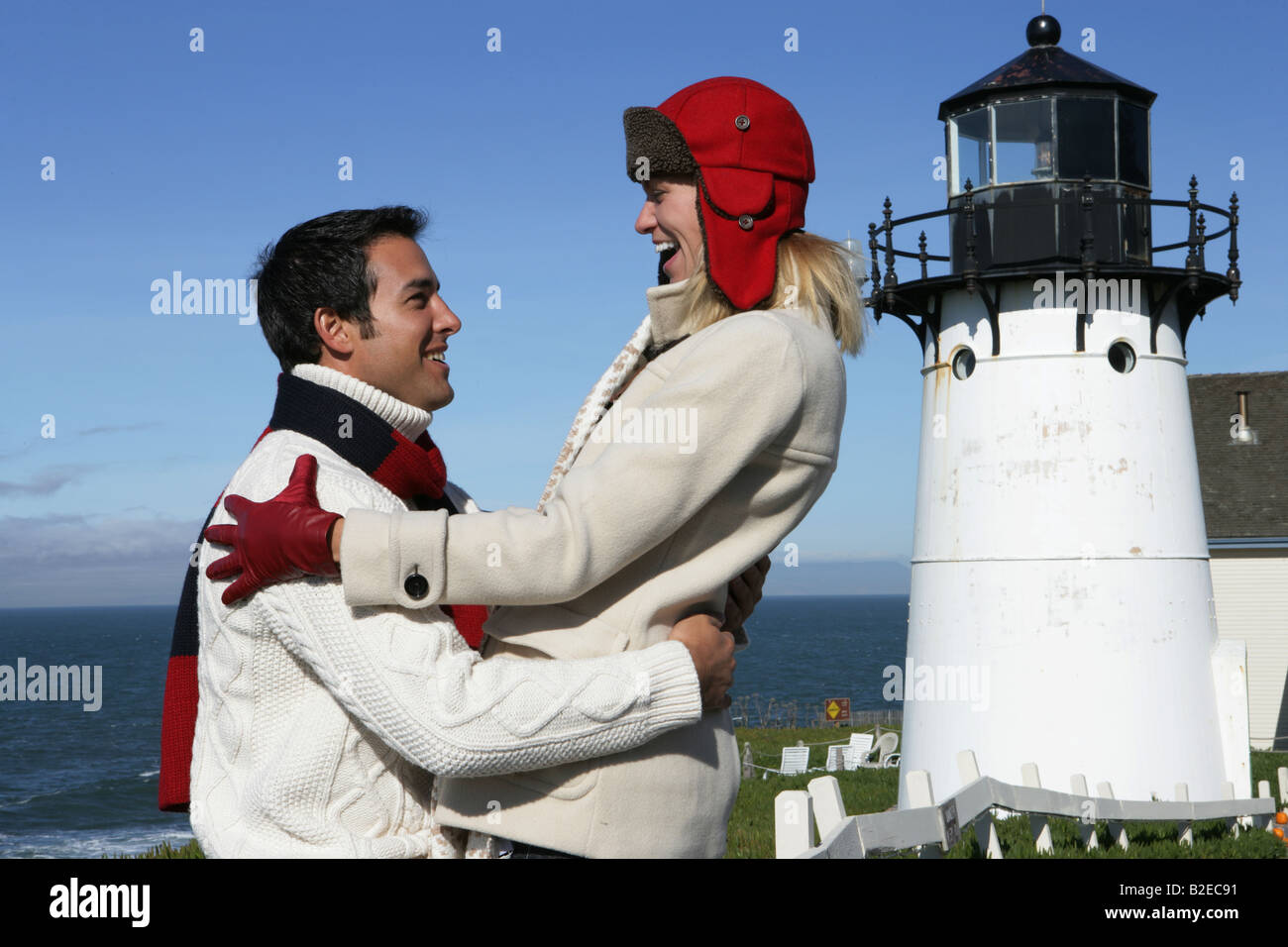 Young happy couple at lighthouse Stock Photo - Alamy