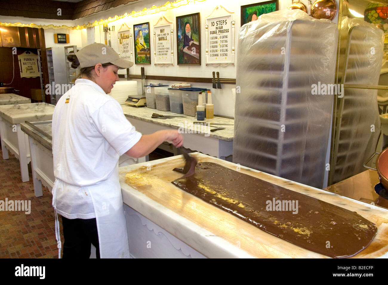 Worker making chocolate fudge at a candy shop in Sault Ste Marie ...