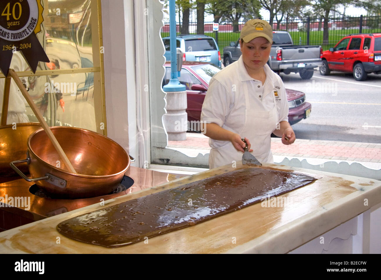 Worker making chocolate fudge at a candy shop in Sault Ste Marie ...