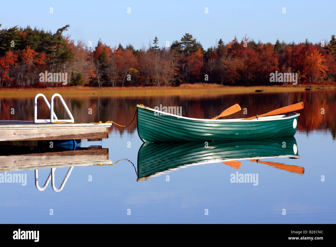 an autumn scenic with a wharf and rowboat at Ponhook Lake in nova ...