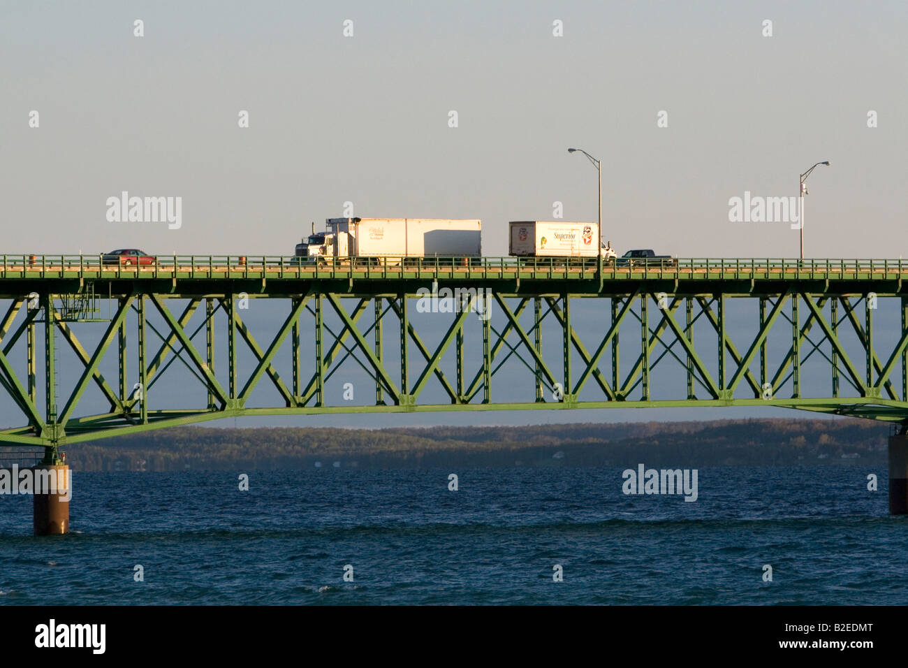 Trucks and autos travel over the Mackinac Bridge spanning the Straits ...