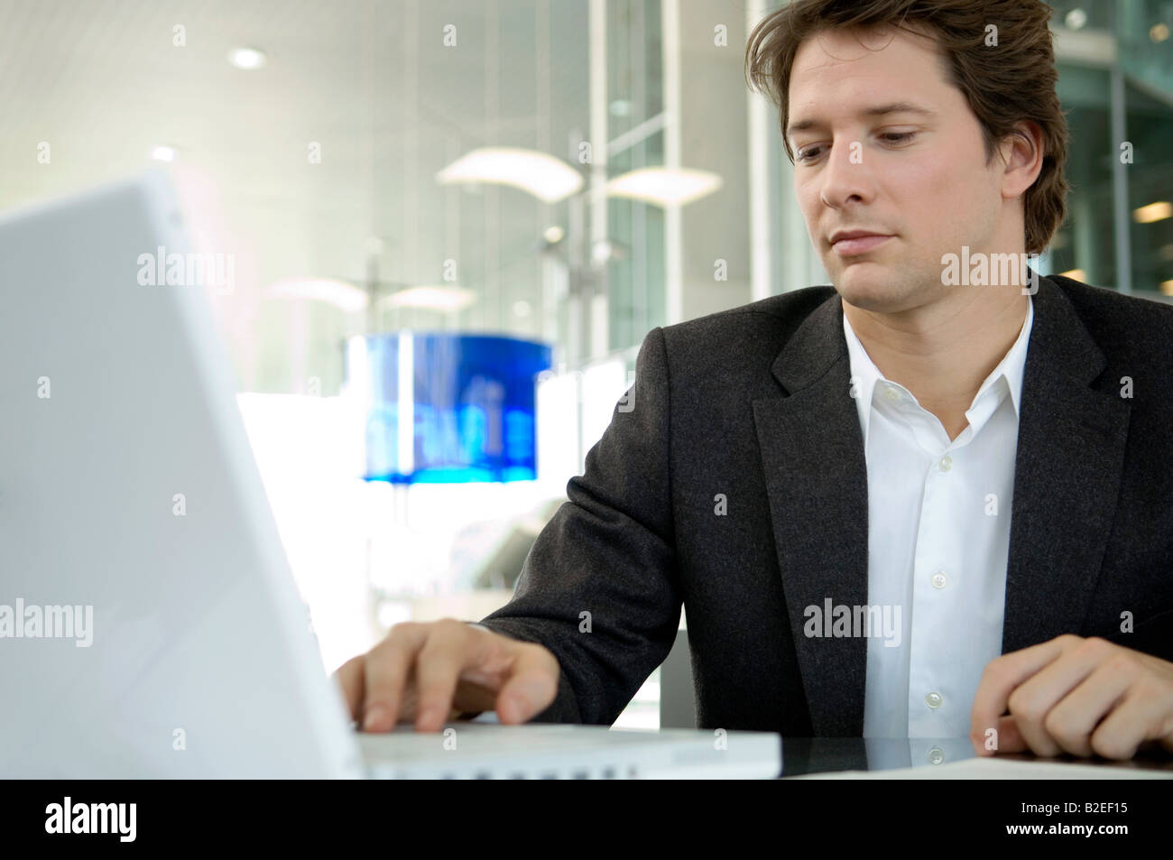 Close-up of a businessman using a laptop in an office Stock Photo - Alamy