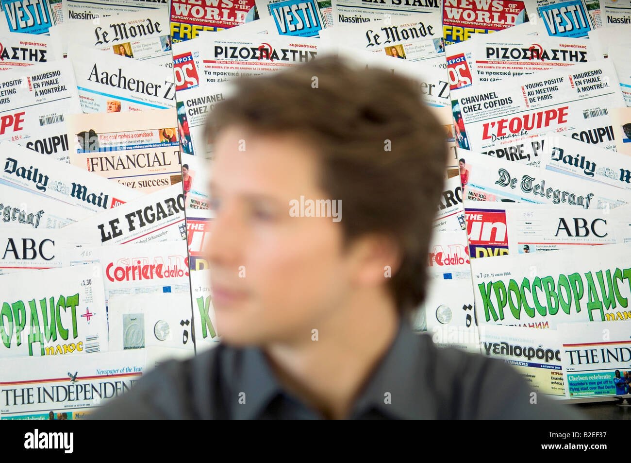 Close-up of a mid adult man in front of a newsstand Stock Photo - Alamy
