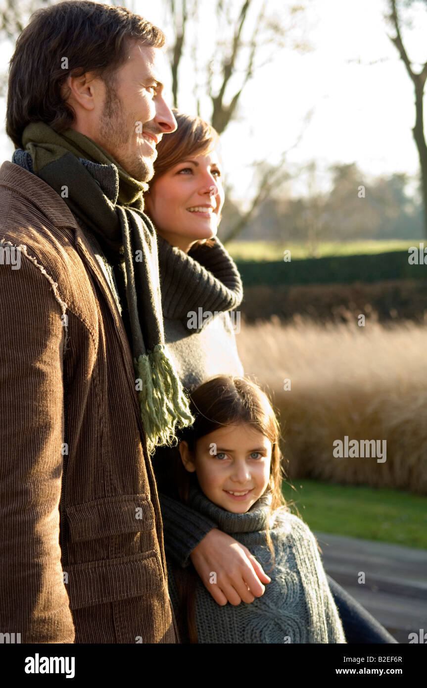 Girl standing with her parents Stock Photo - Alamy