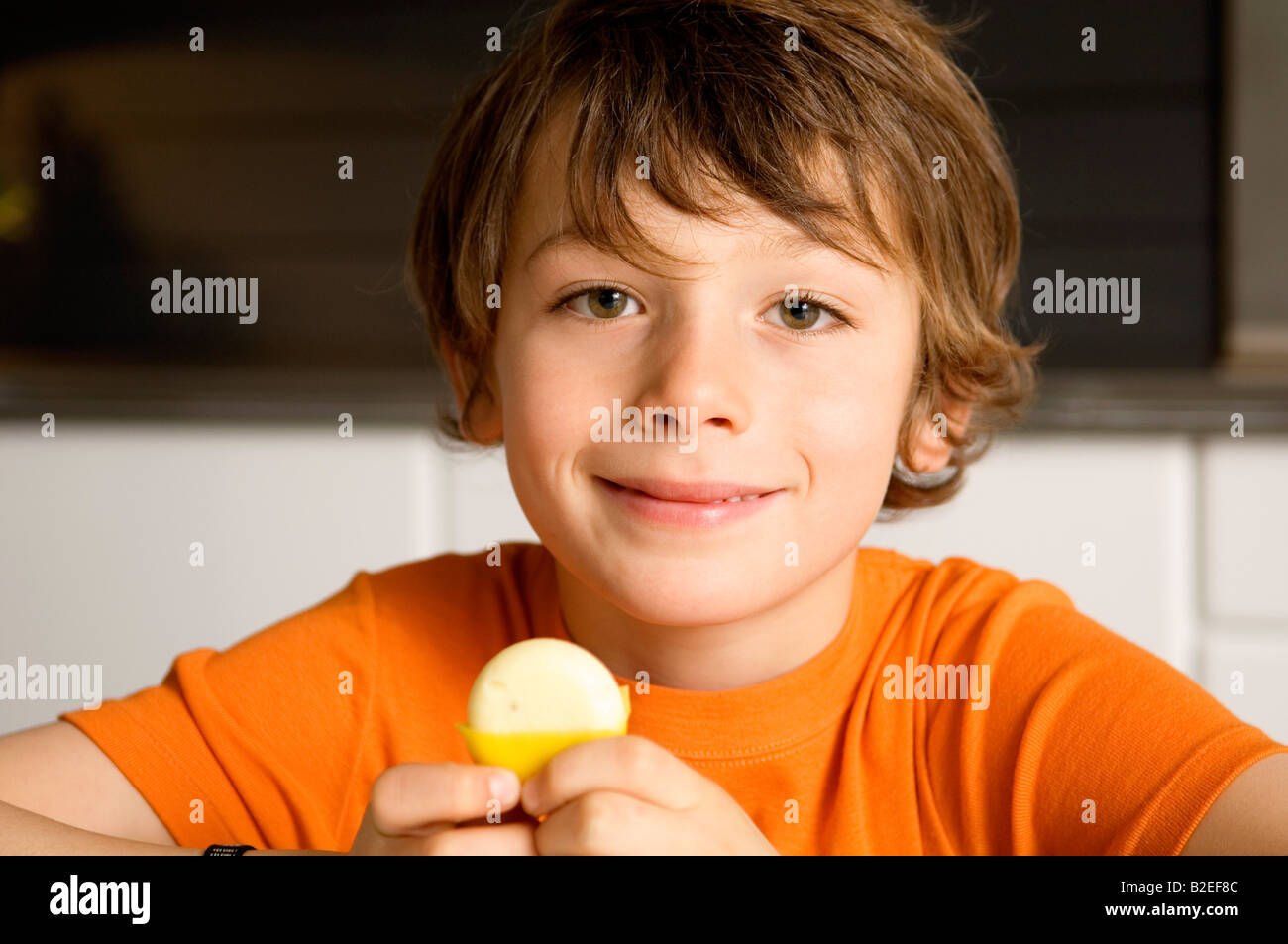 Portrait of a boy holding cheese Stock Photo - Alamy