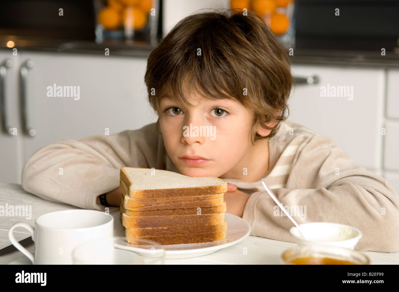 Portrait of a boy having breakfast Stock Photo - Alamy