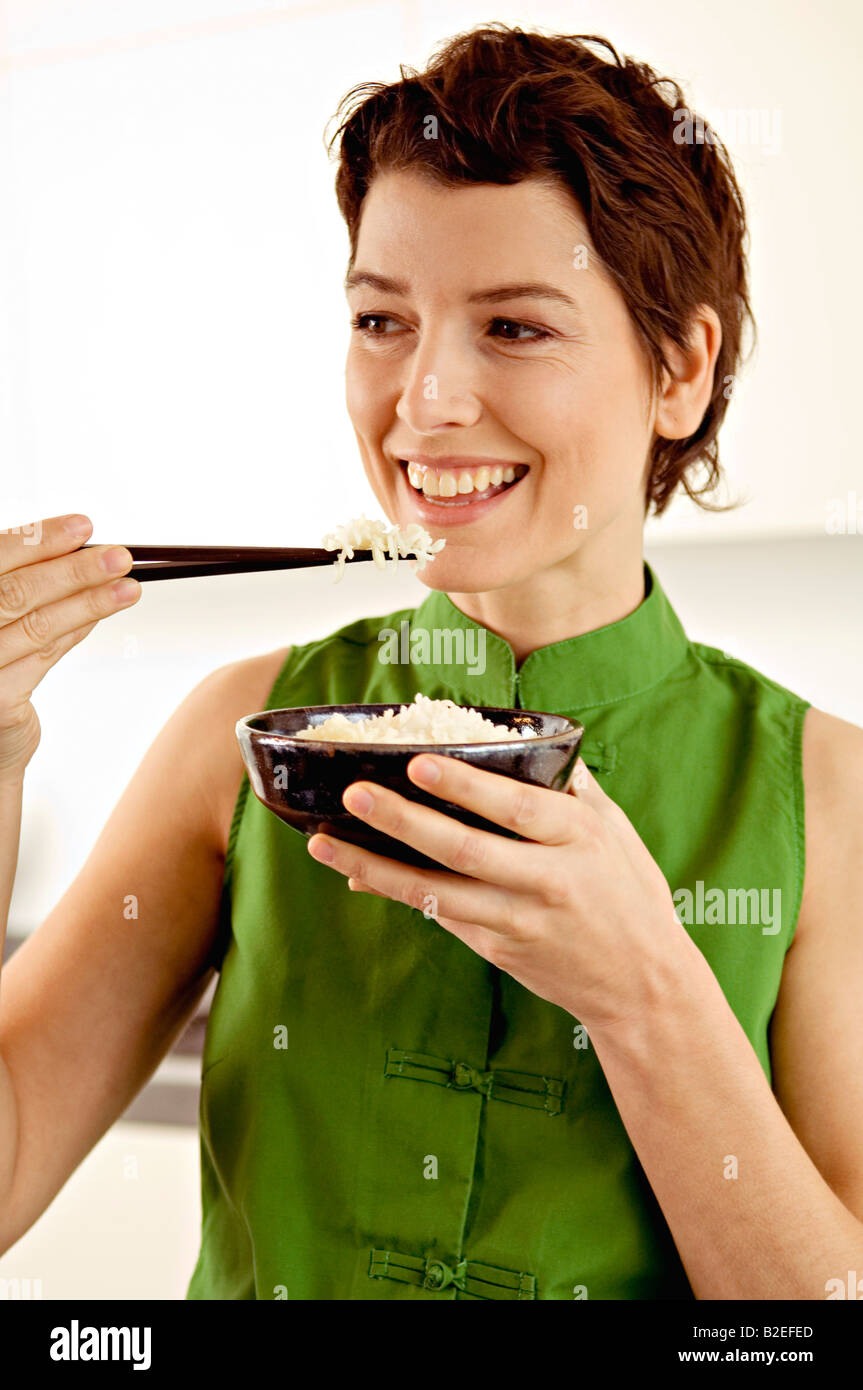 Woman eating rice vertical hi-res stock photography and images - Alamy