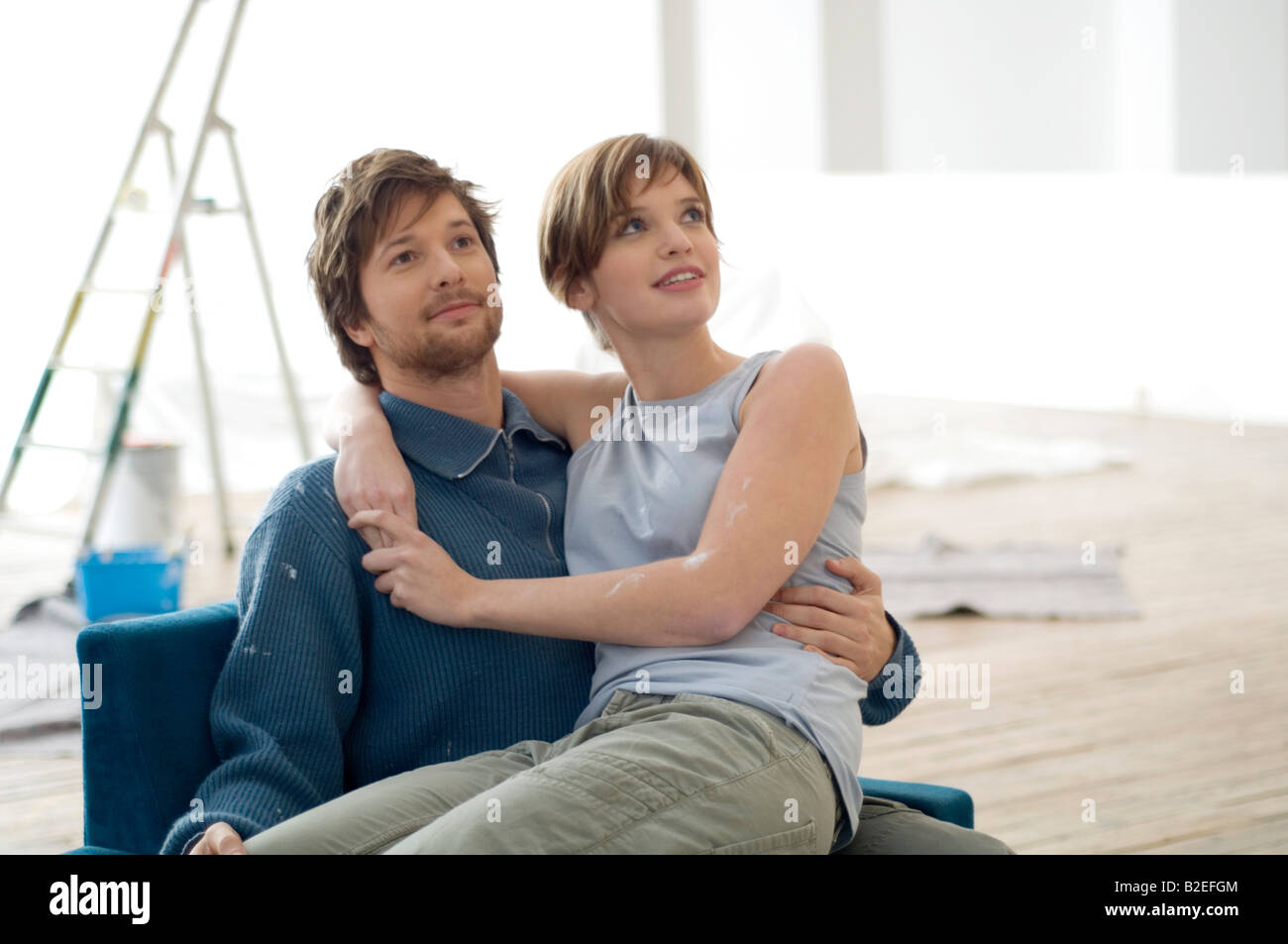 Young woman sitting on the lap of a mid adult man Stock Photo - Alamy