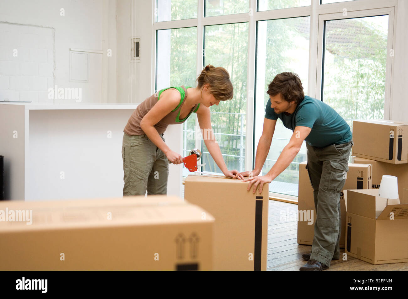Couple packing cardboard boxes Stock Photo - Alamy