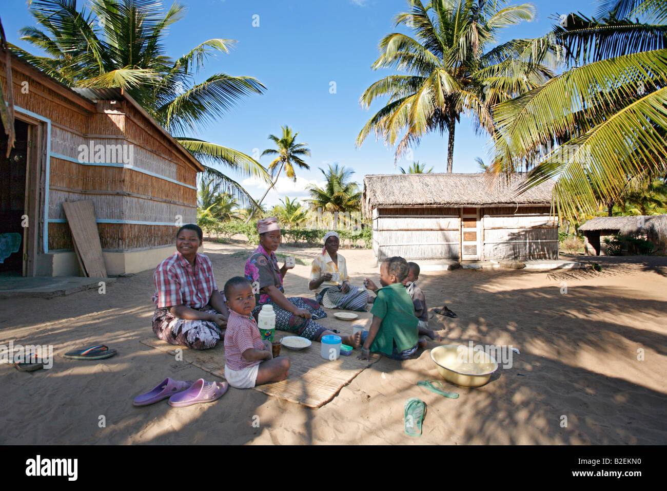 A local family gathering outside their house to have tea while seated ...