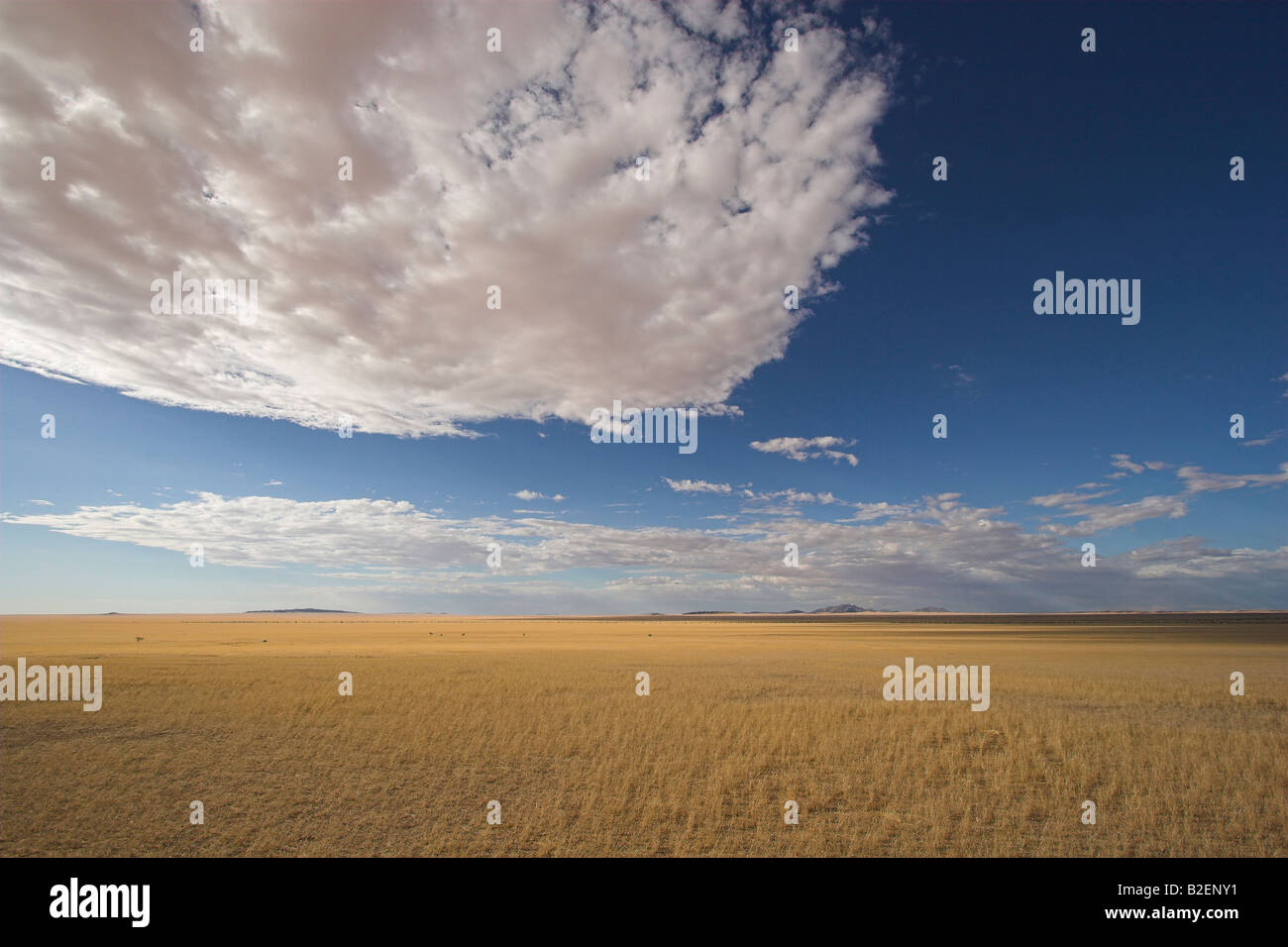 A flat desert landscape with clouds Stock Photo - Alamy