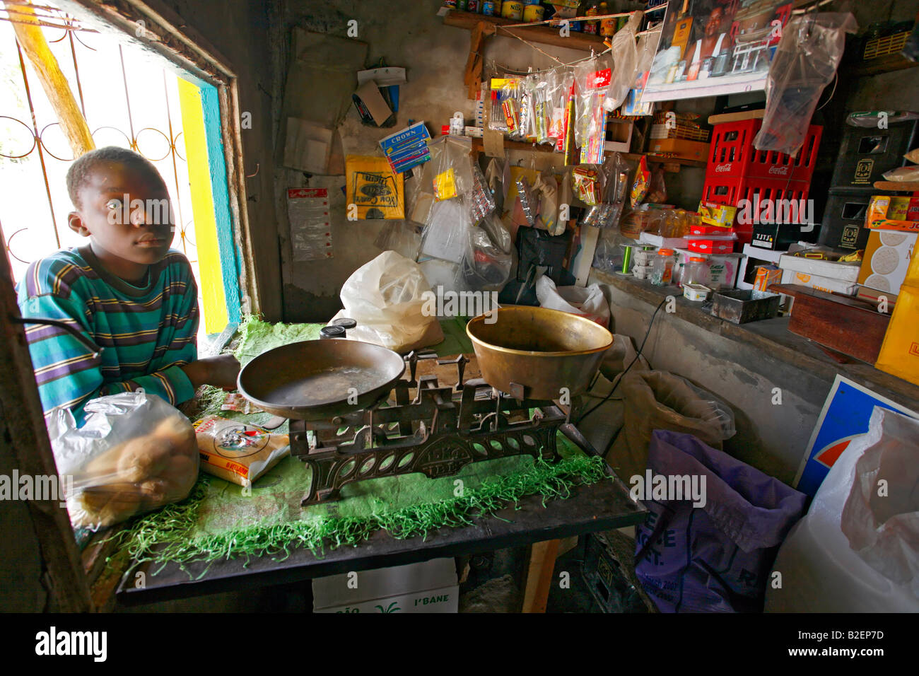 A boy looking into a rural store in Mozambique Stock Photo - Alamy