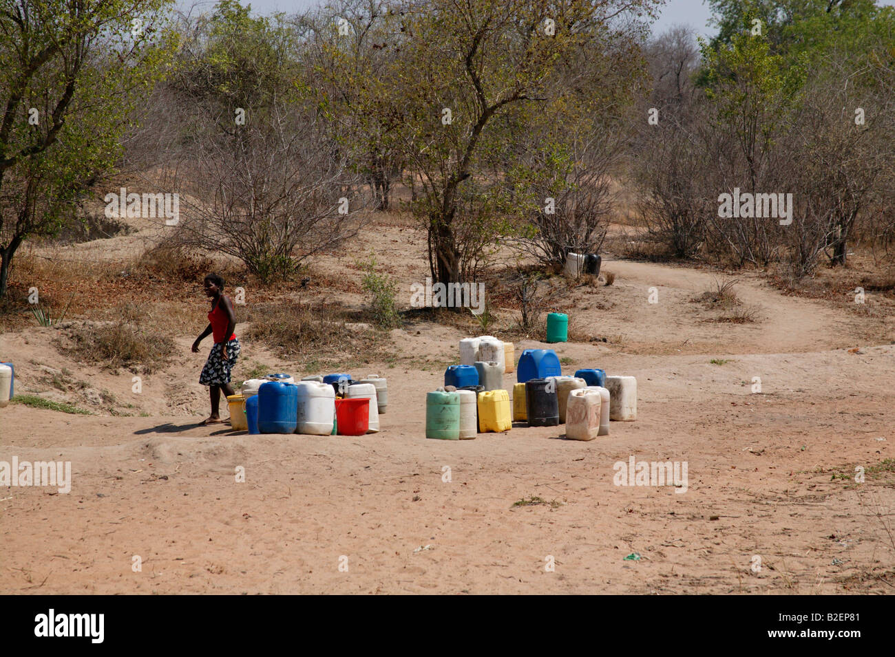A variety of plastic water containers lined up at a well near Masangena ...