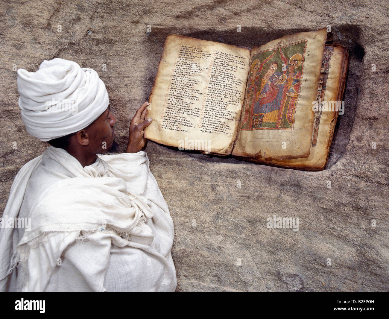 A Priest of the Ethiopian Orthodox Church reads a very old, beautifully ...