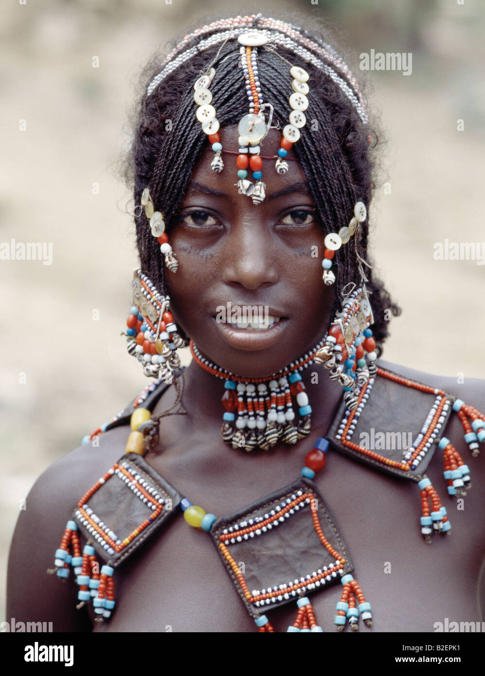 A young Afar girl at Senbete market. Her elaborately decorated ...
