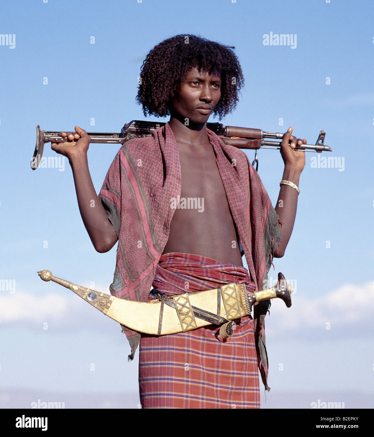 Warriors of the nomadic Afar tribe wear their hair long and carry large ...