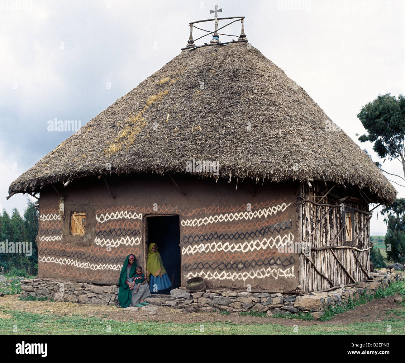 An attractively decorated traditional thatched house belonging to an ...