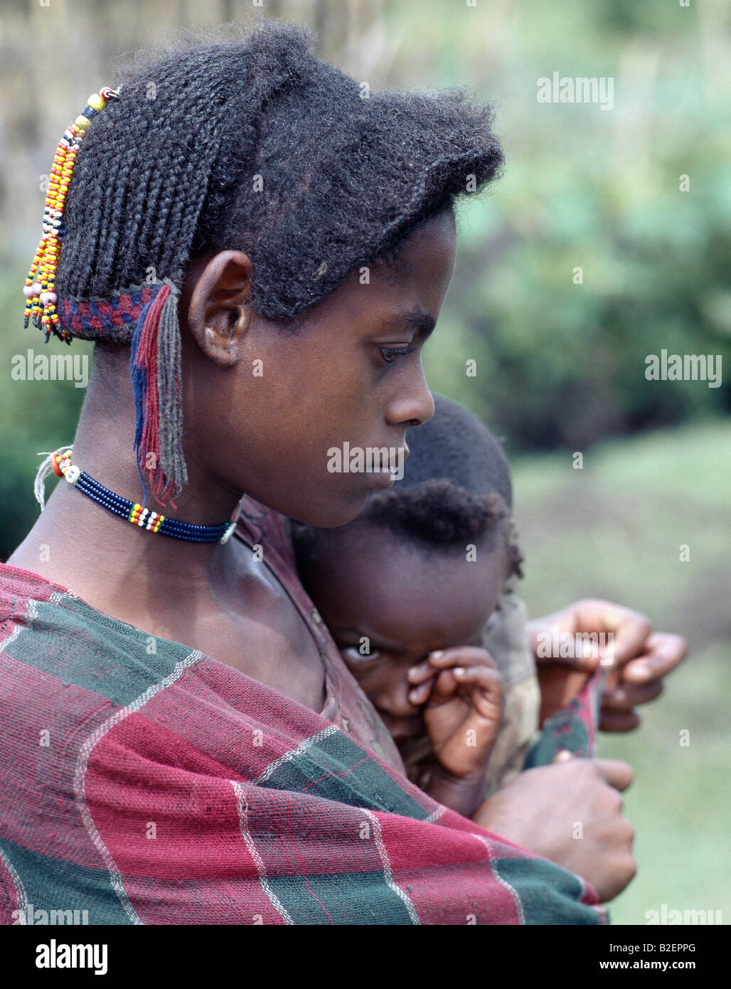 A young mother and child of the Arsi-Oromo people west of Aje. Both ...