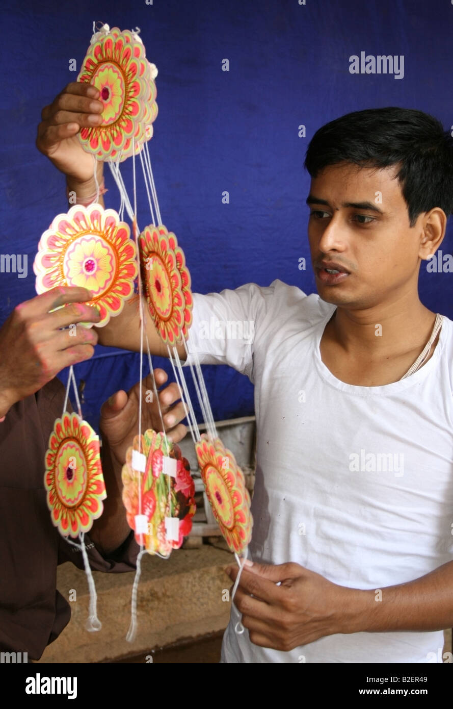 Hindu priest with decorations for a Durga shrine for Dasara ...