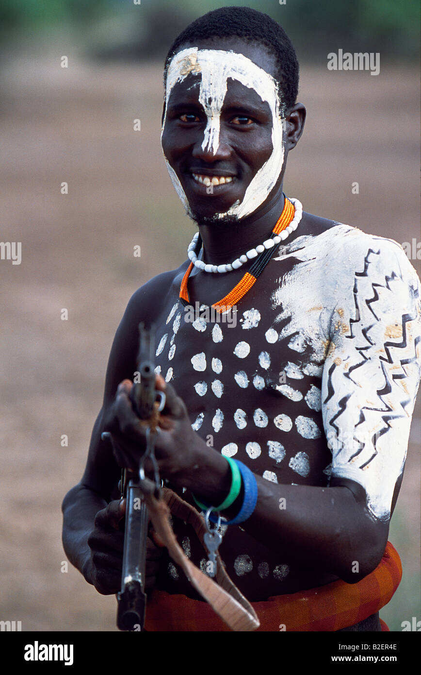 A Nyangatom warrior has painted his body and face in preparation for a ...