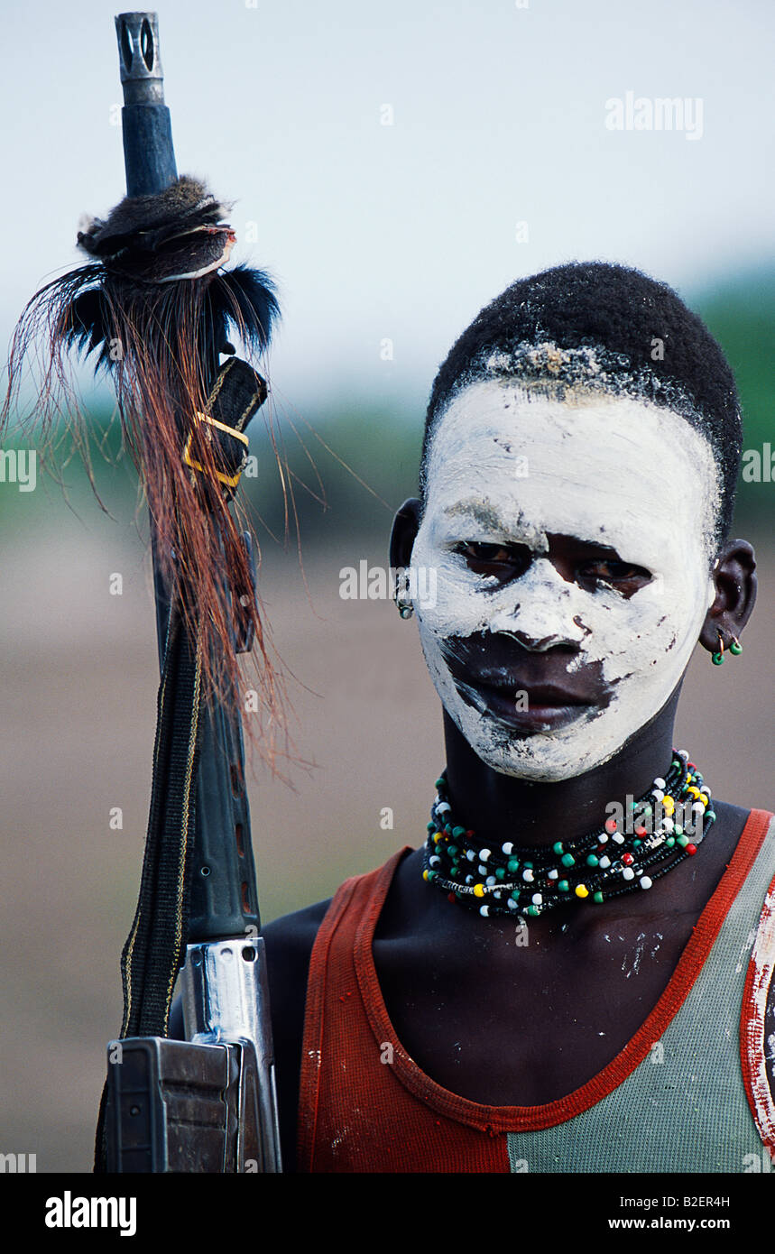 A Nyangatom warrior has painted his body and face in preparation for a ...