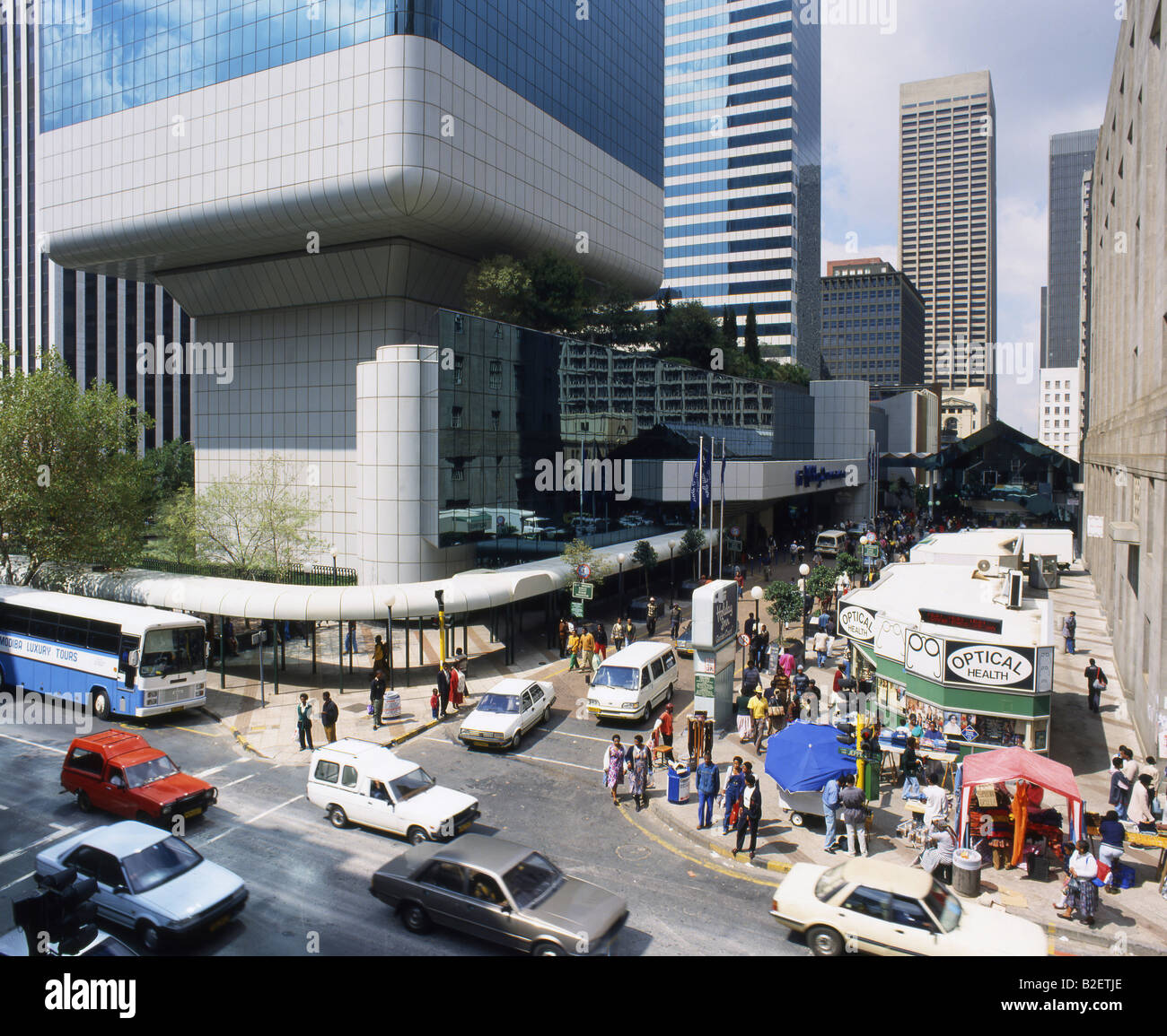 Pedestrians and traffic amidst high rise buildings at Small Street Mall ...