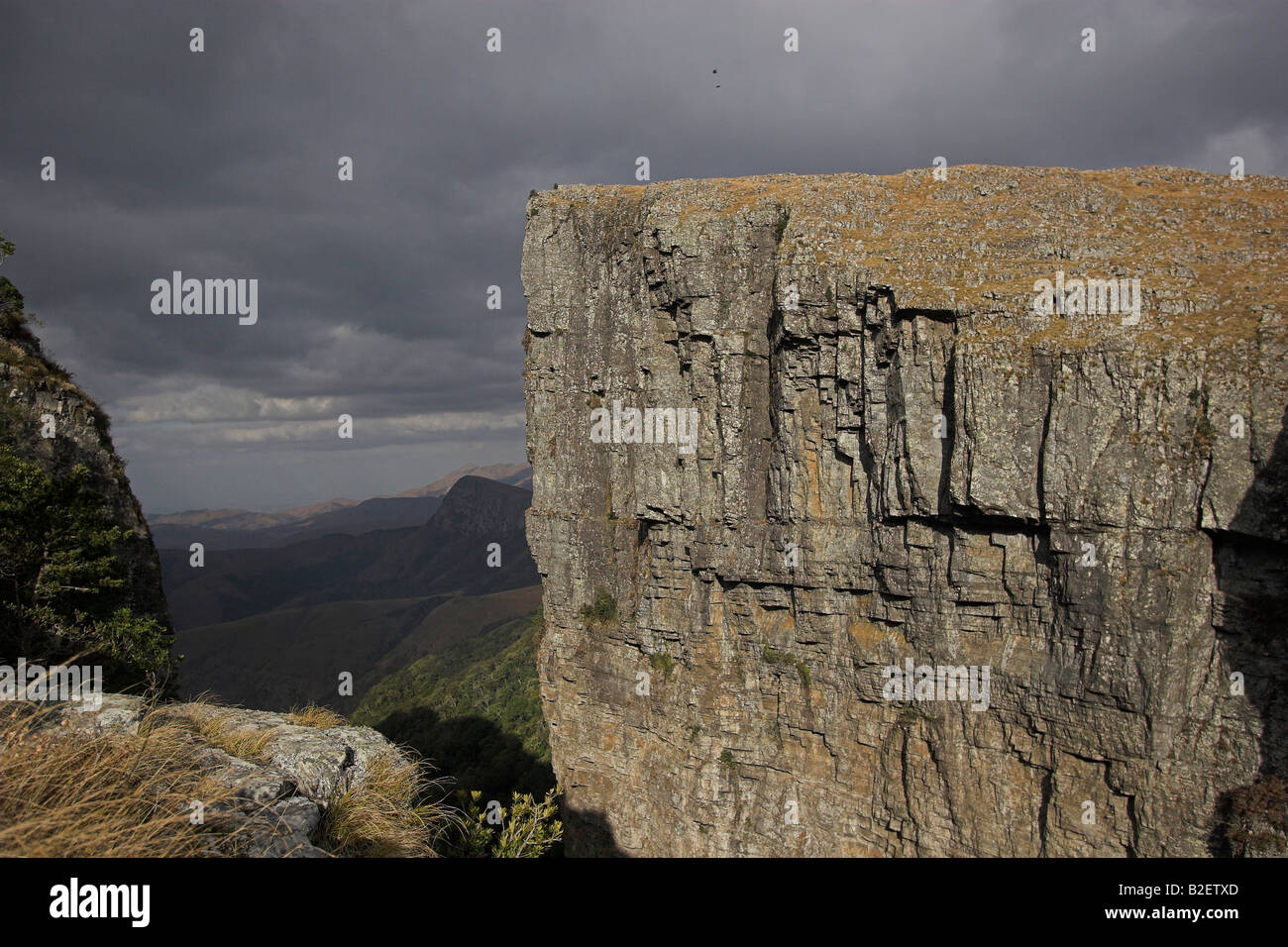 Mountain landscape showing a sheer rock face and the landscape beyond ...