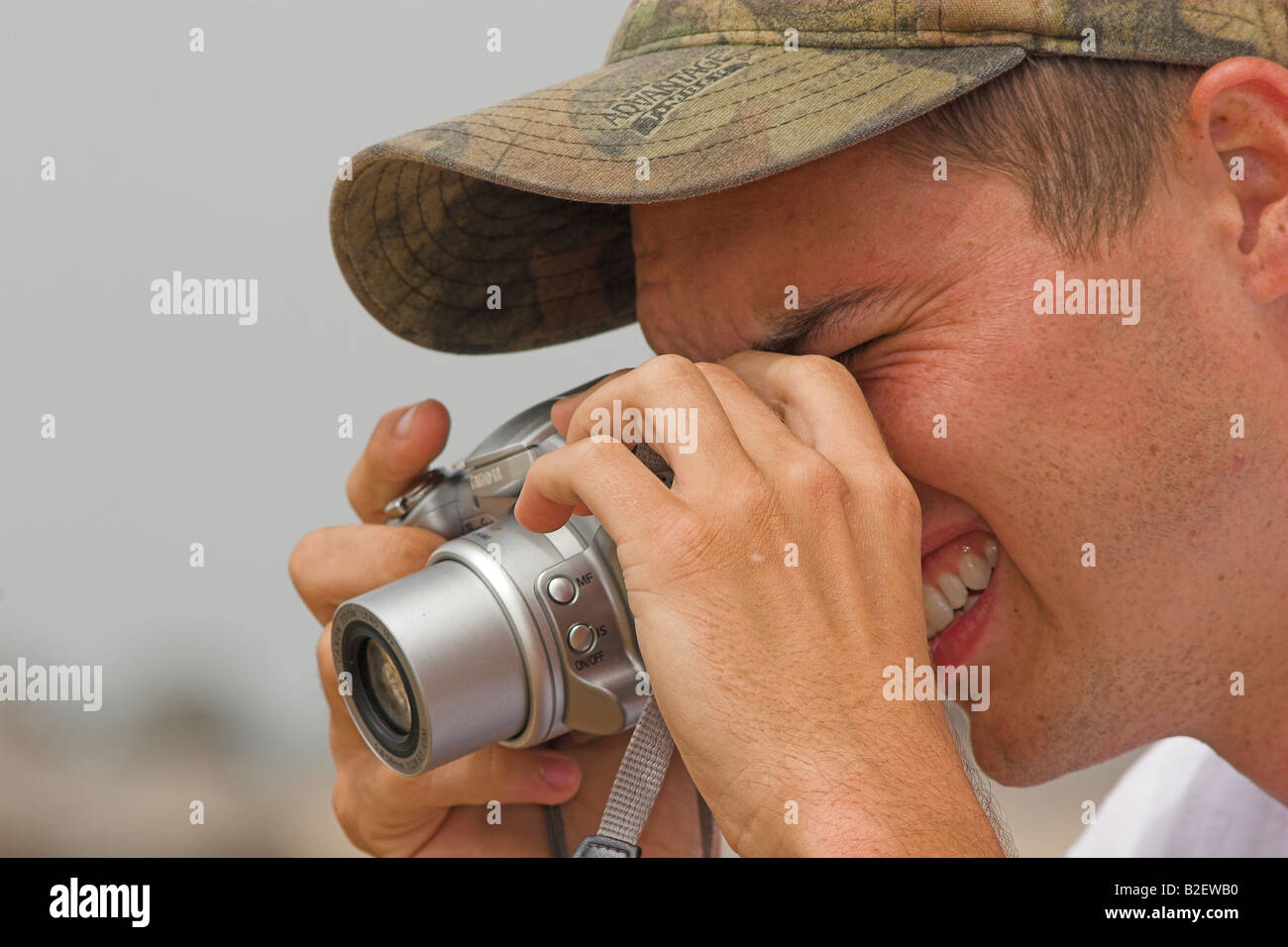 Young boy focussing his camera Stock Photo - Alamy