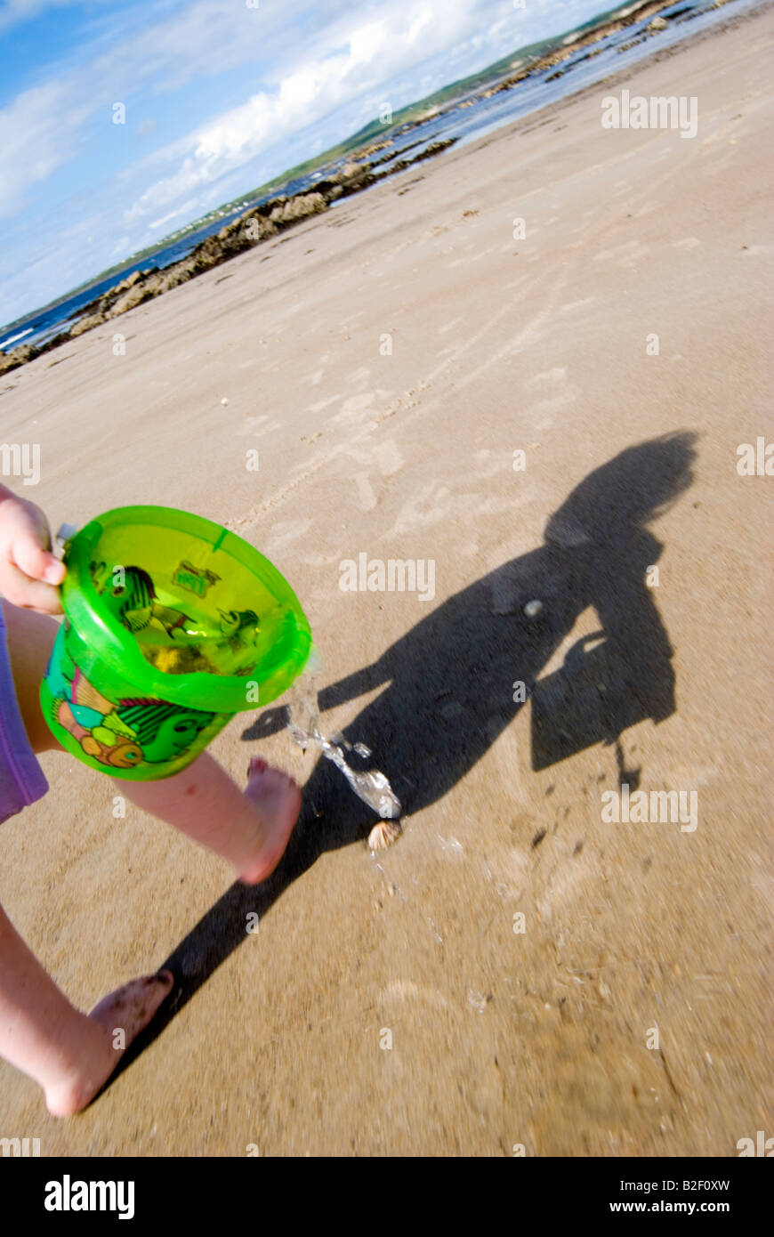 Ardara County Donegal Ireland Child plays on beach with water and ...