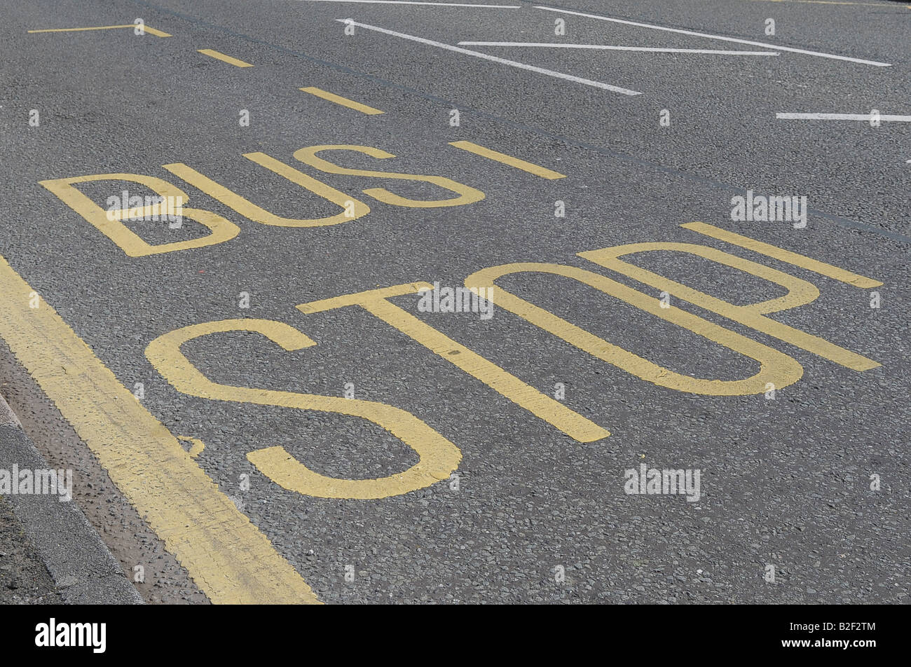 bus stop road marking yellow england uk Stock Photo - Alamy