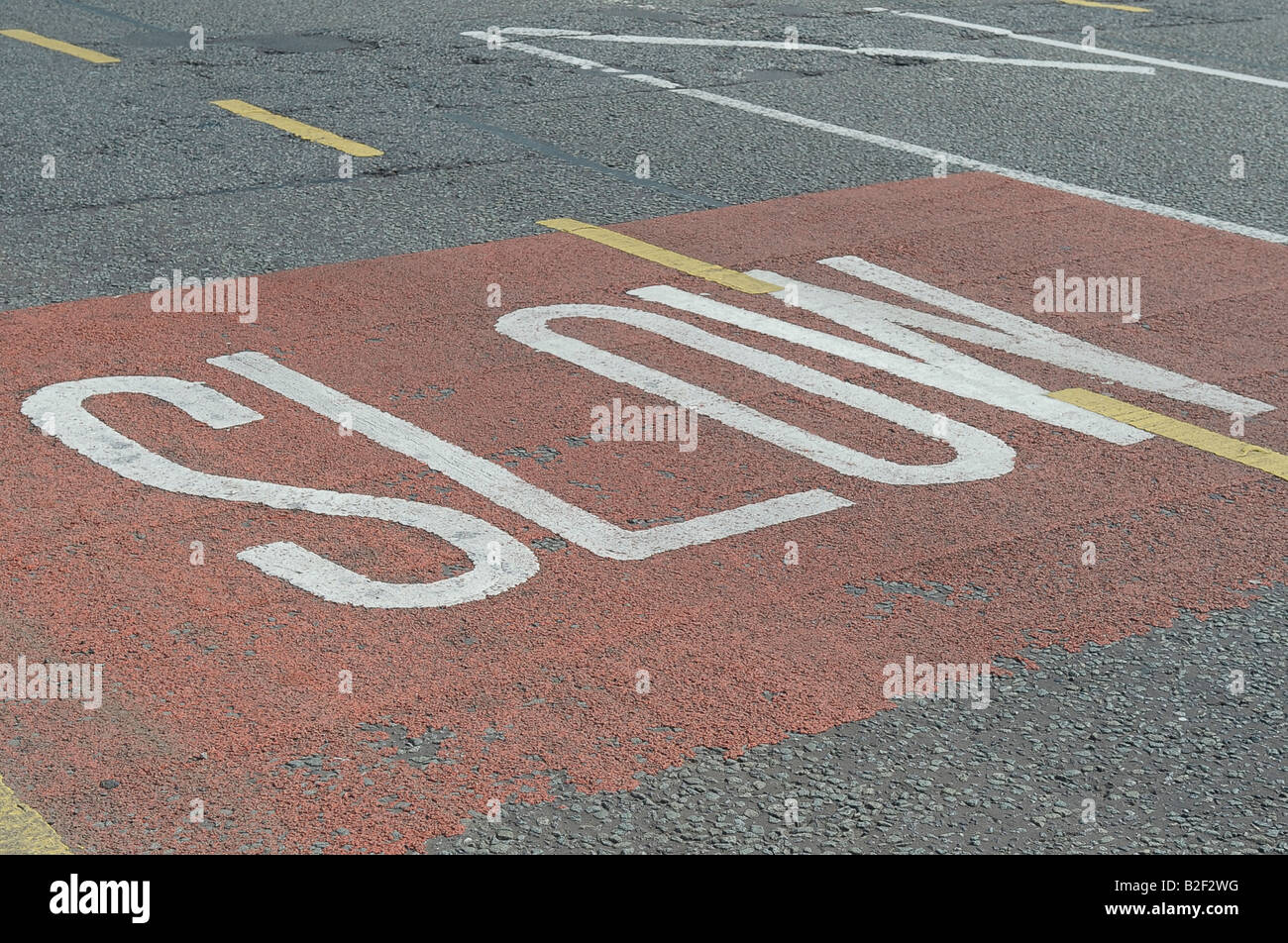 slow road marking traffic calming measure speed Stock Photo - Alamy